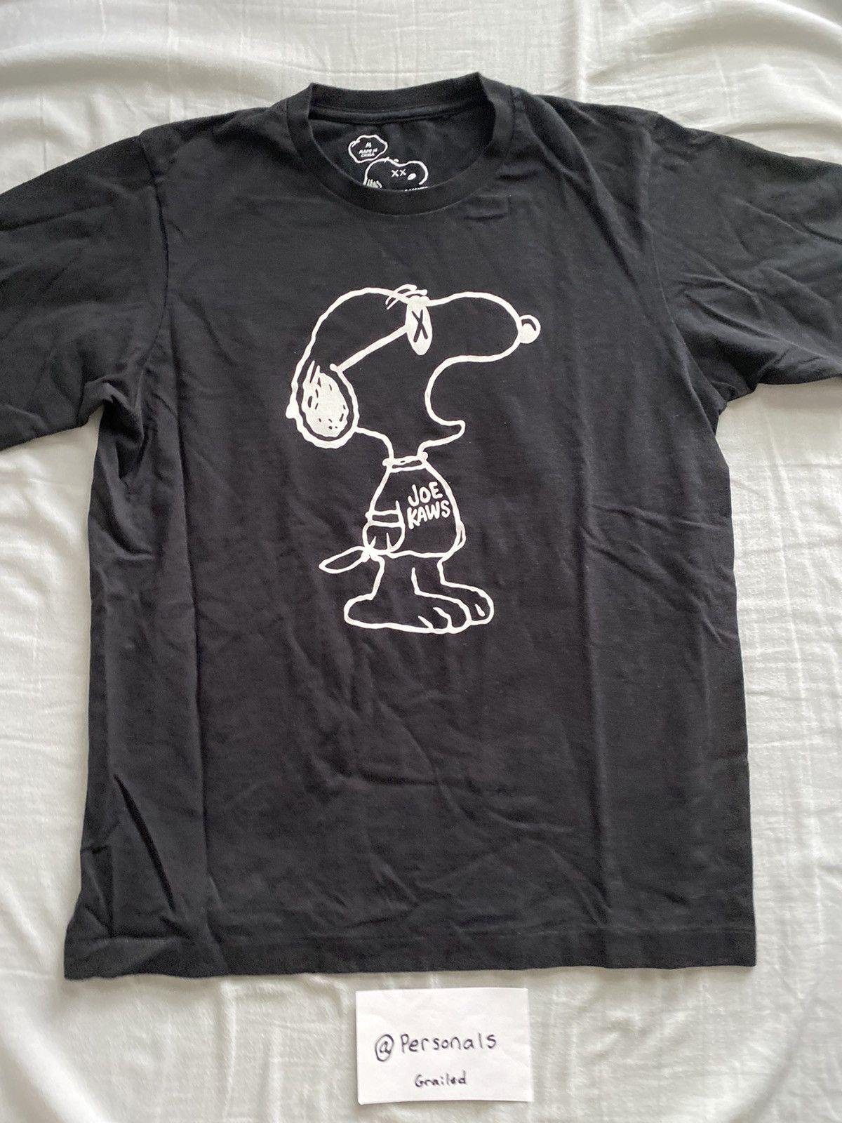 Kaws × Uniqlo Kaws Uniqlo Peanuts Joe Kaws Yawn Outline Tee Black | Grailed