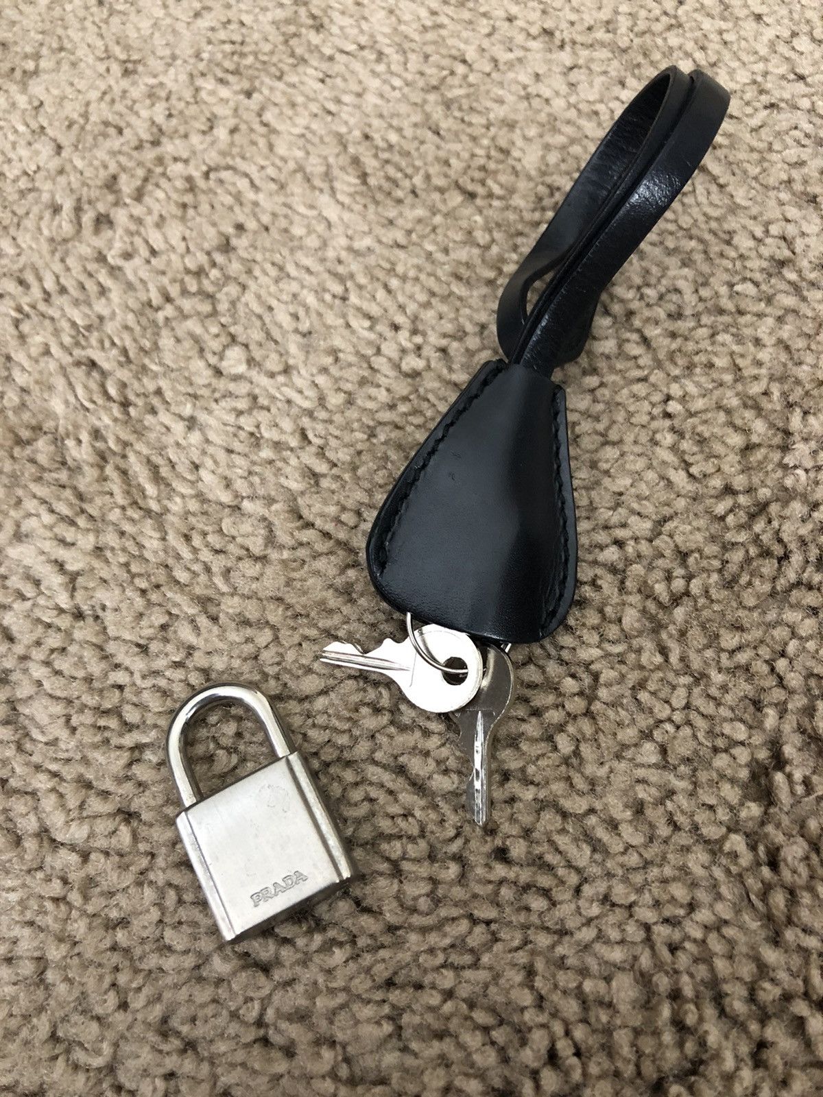 Prada Prada silver tone lock and key | Grailed
