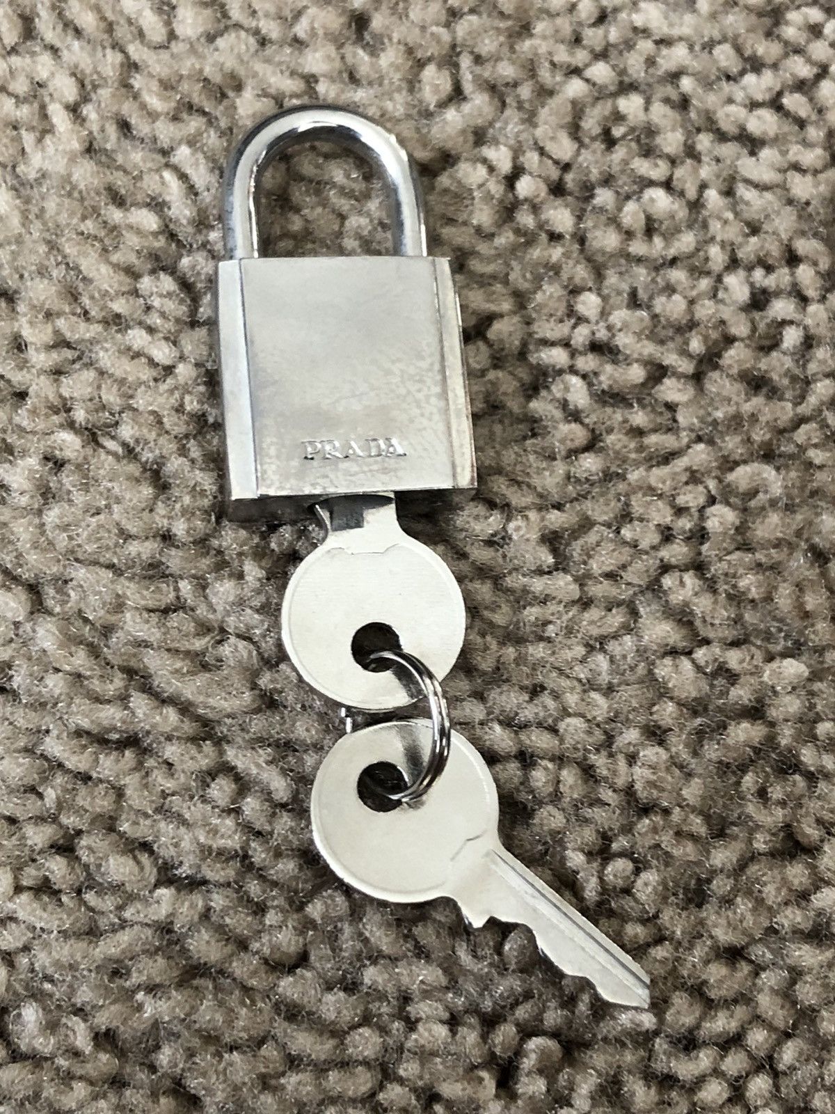 Prada Prada silver tone lock | Grailed