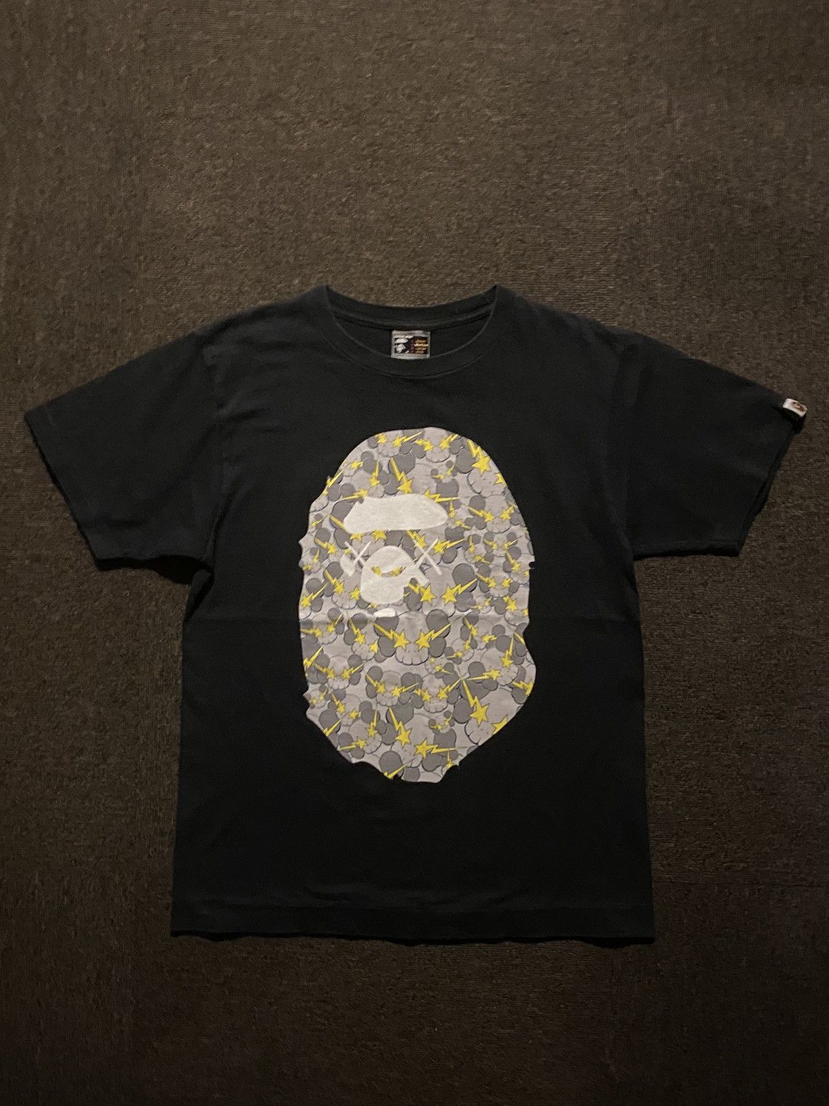 Bape A Bathing Ape x Kaws Big Ape Head Skullsta camo Tee | Grailed