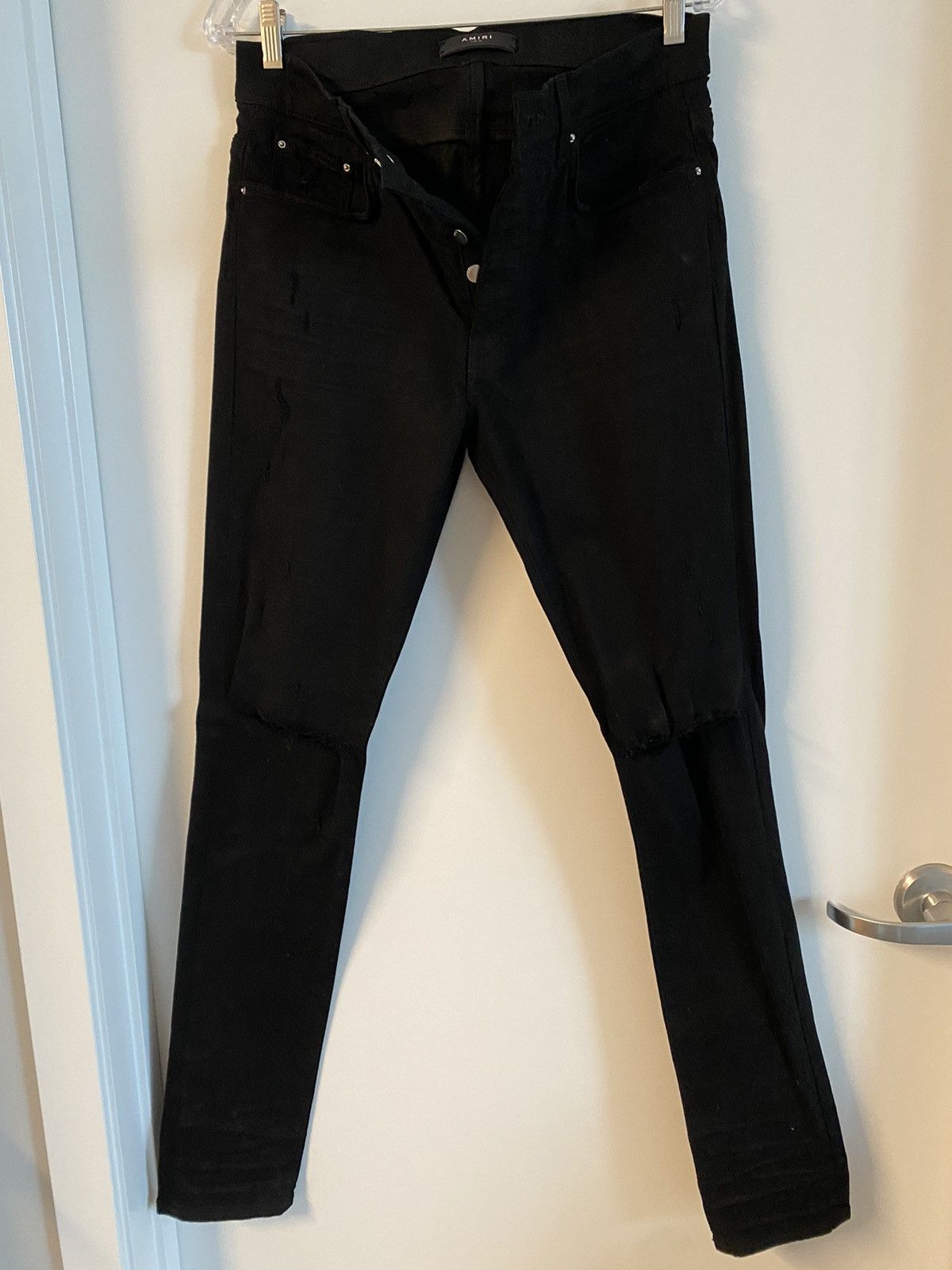 Amiri Amiri all black ripped jeans | Grailed