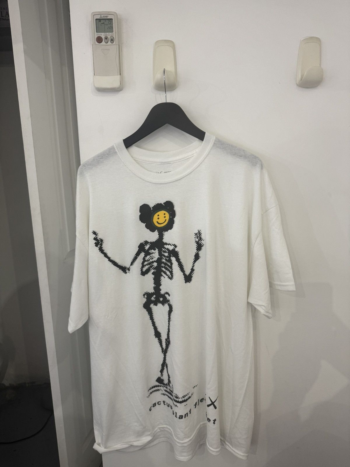 Cactus Plant Flea Market × Kaws Sunflower tee | Grailed