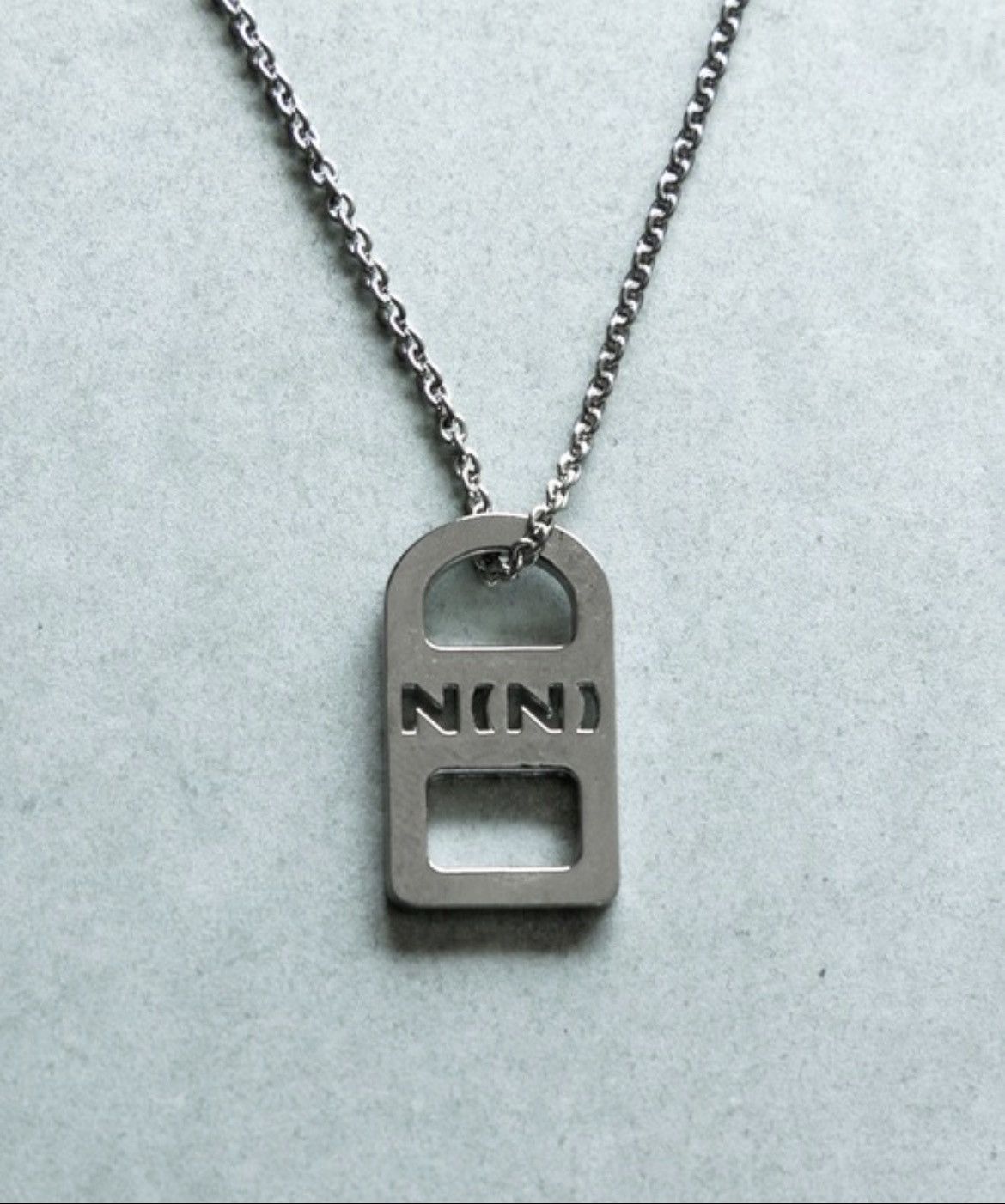 Number (N)ine NUMBER NINE LOGO PLATE HOLE NECKLACE | Grailed