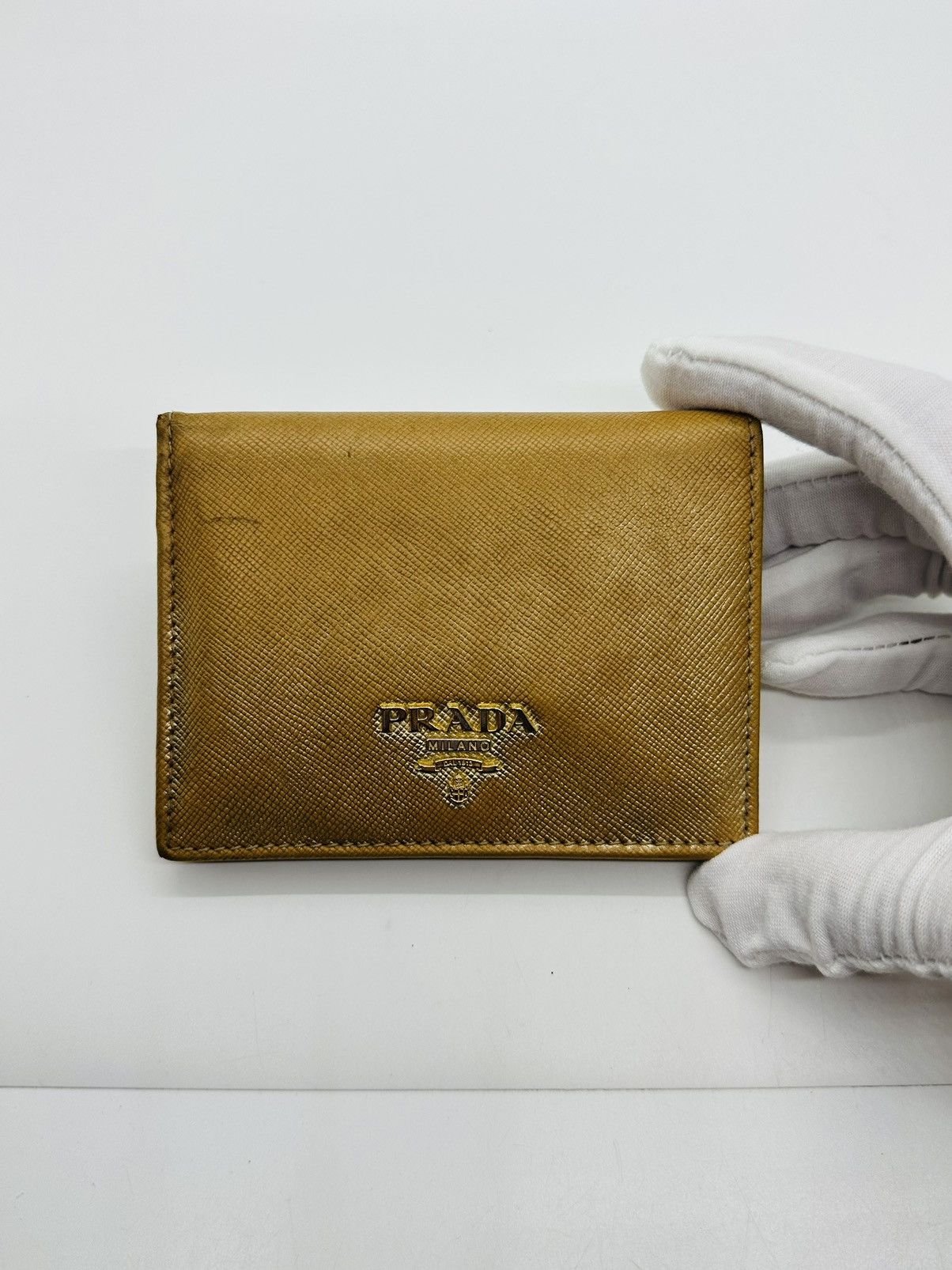 Prada Prada Gold tone bi fold wallet | Grailed