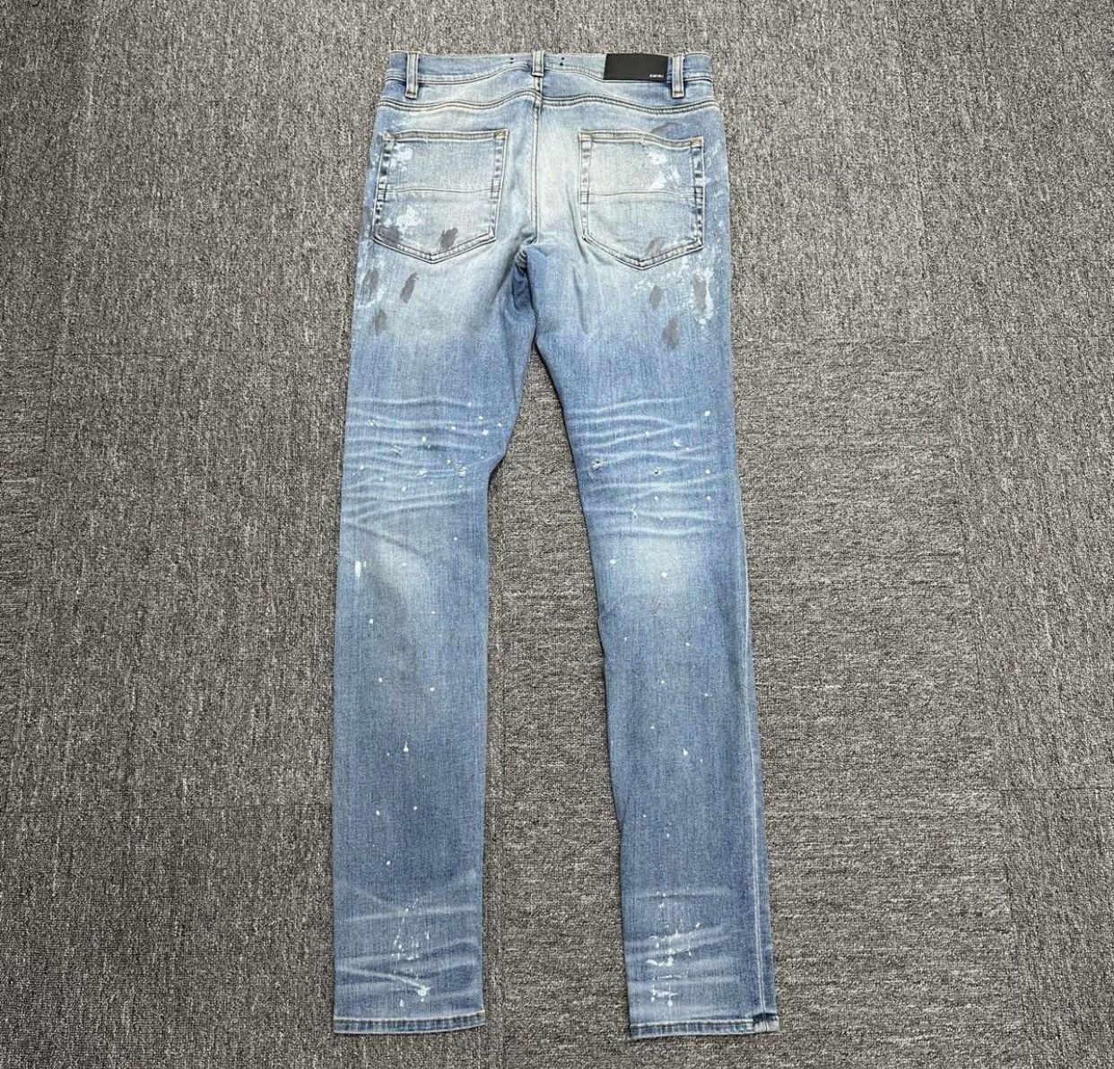 Amiri Amiri destroyed splash-ink jeans on one knee | Grailed