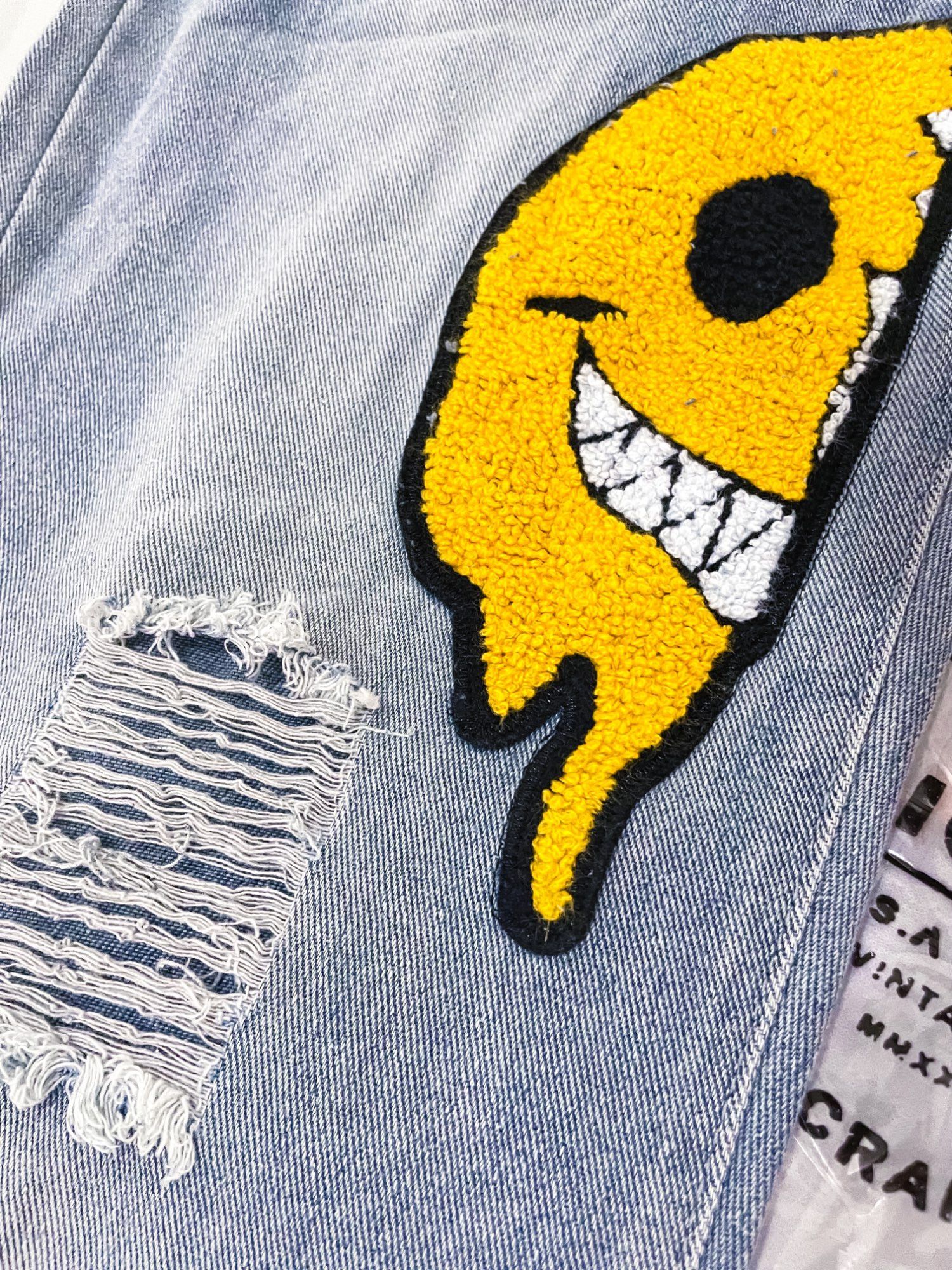 Designer ripped jeans with smiley | Grailed